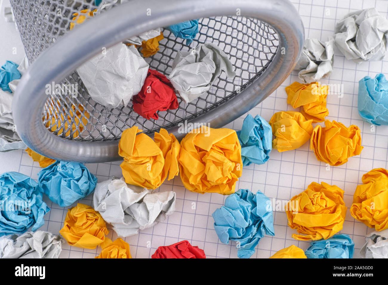 Colorful paper balls rolling out of a trash can. Idea Concept. Close up ...