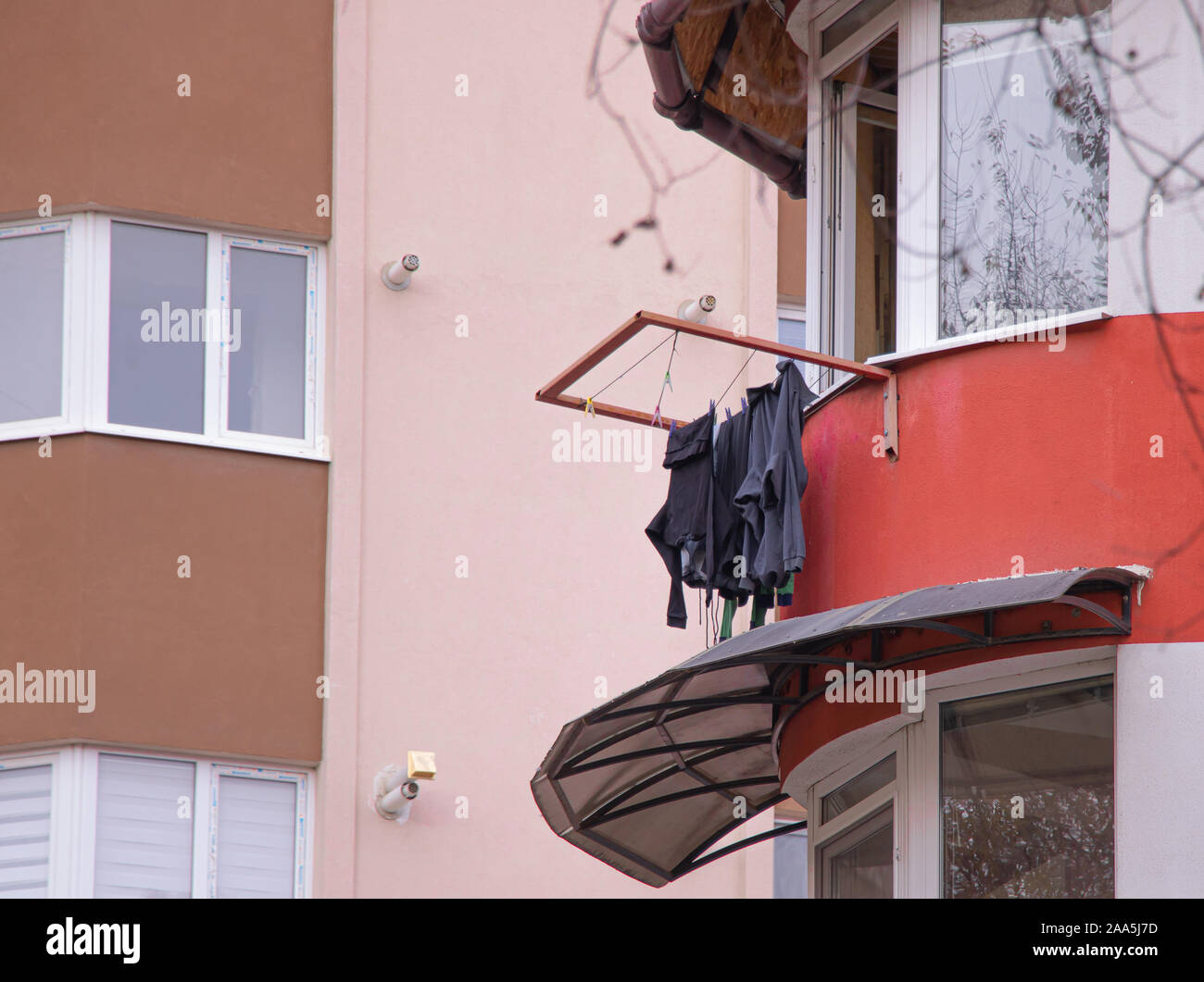 Clothes on a cable to the balcony put to dry Stock Photo - Alamy