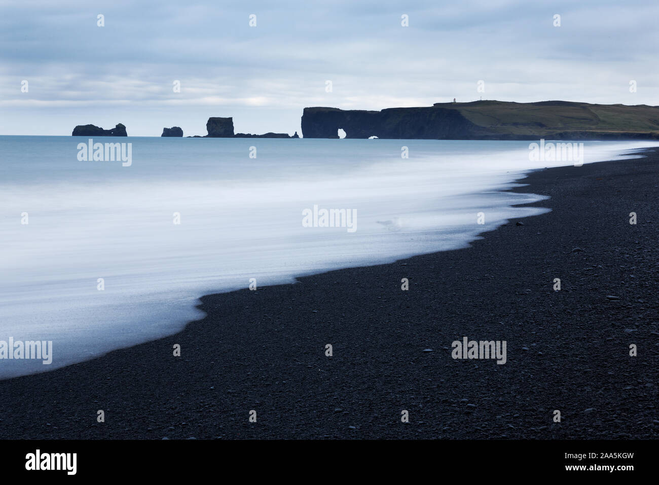 Dyrholaey arch from Reynisfjara black sand beach coast of the Atlantic ...