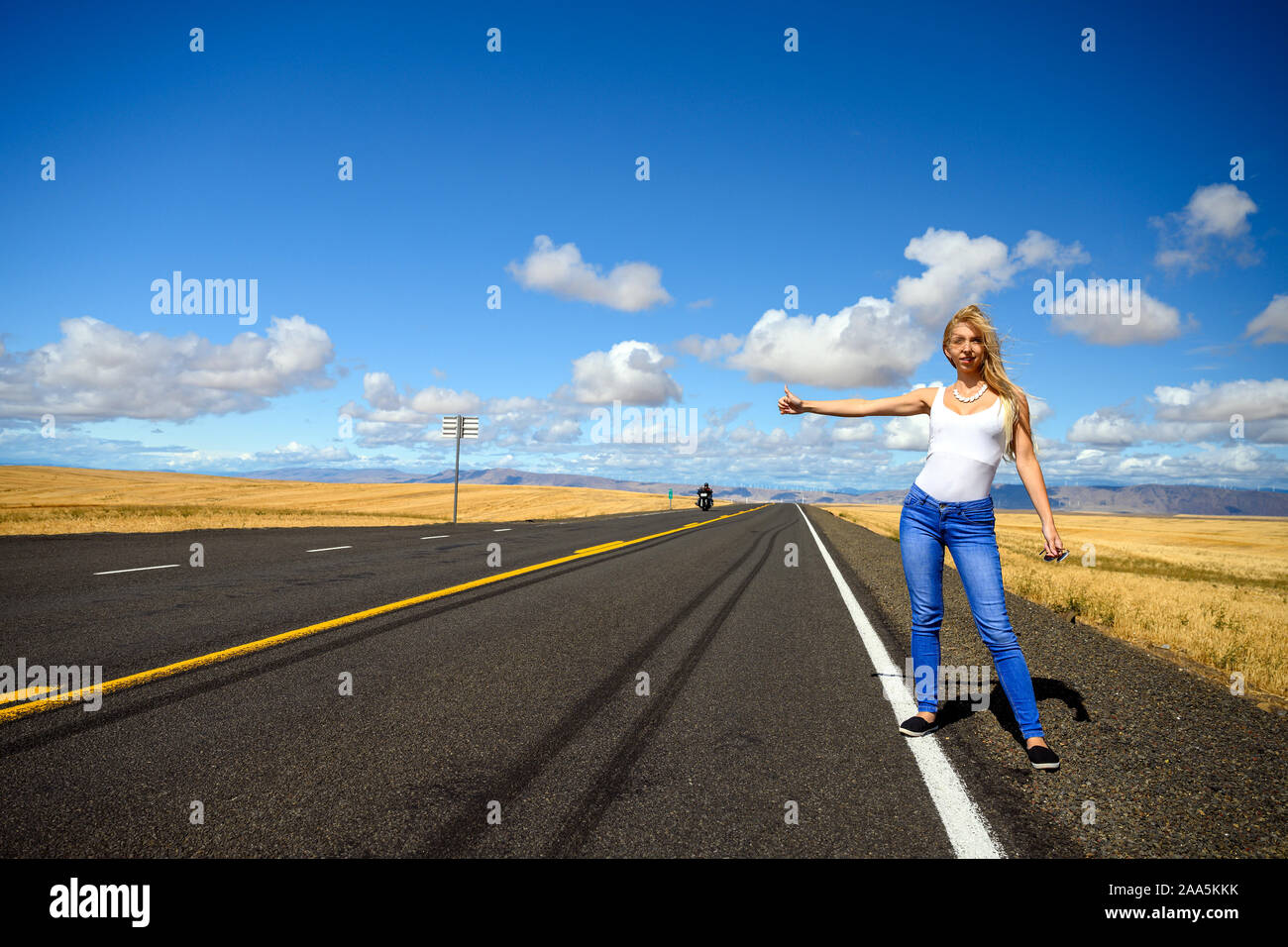 Woman sitting on suitcase roadside hi-res stock photography and images ...