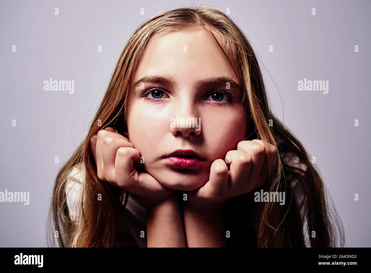 Portrait of a cute pensive teenage girl with long hair. Pretty woman ...