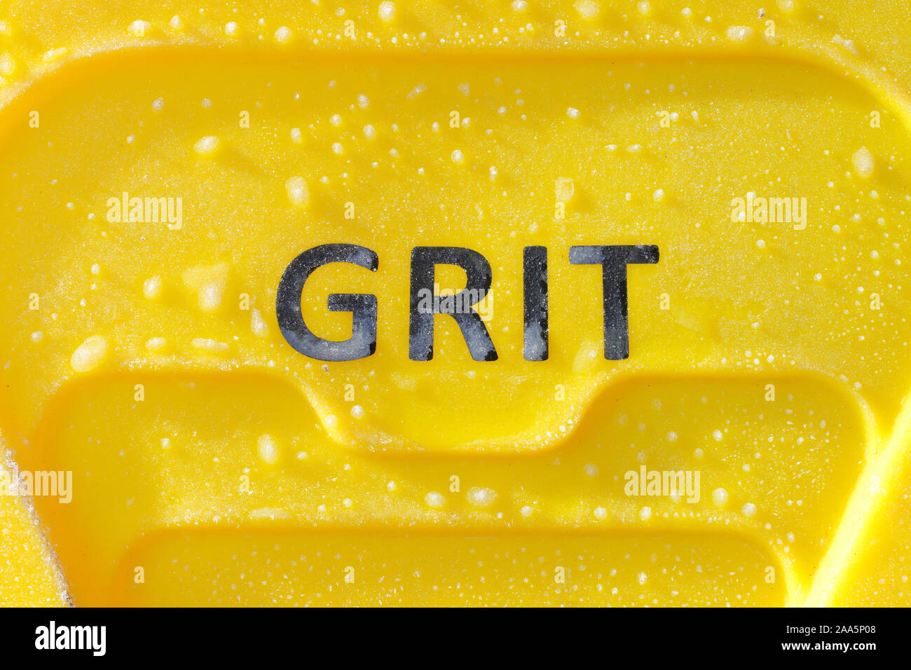 A yellow grit bin that has frozen over Stock Photo - Alamy