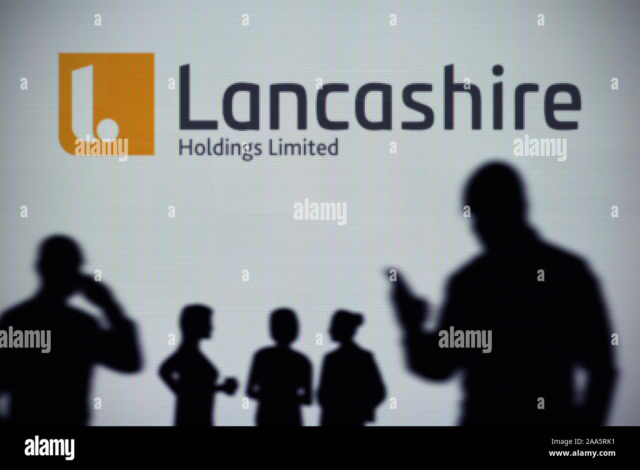 The Lancashire Holdings logo is seen on an LED screen in the background ...
