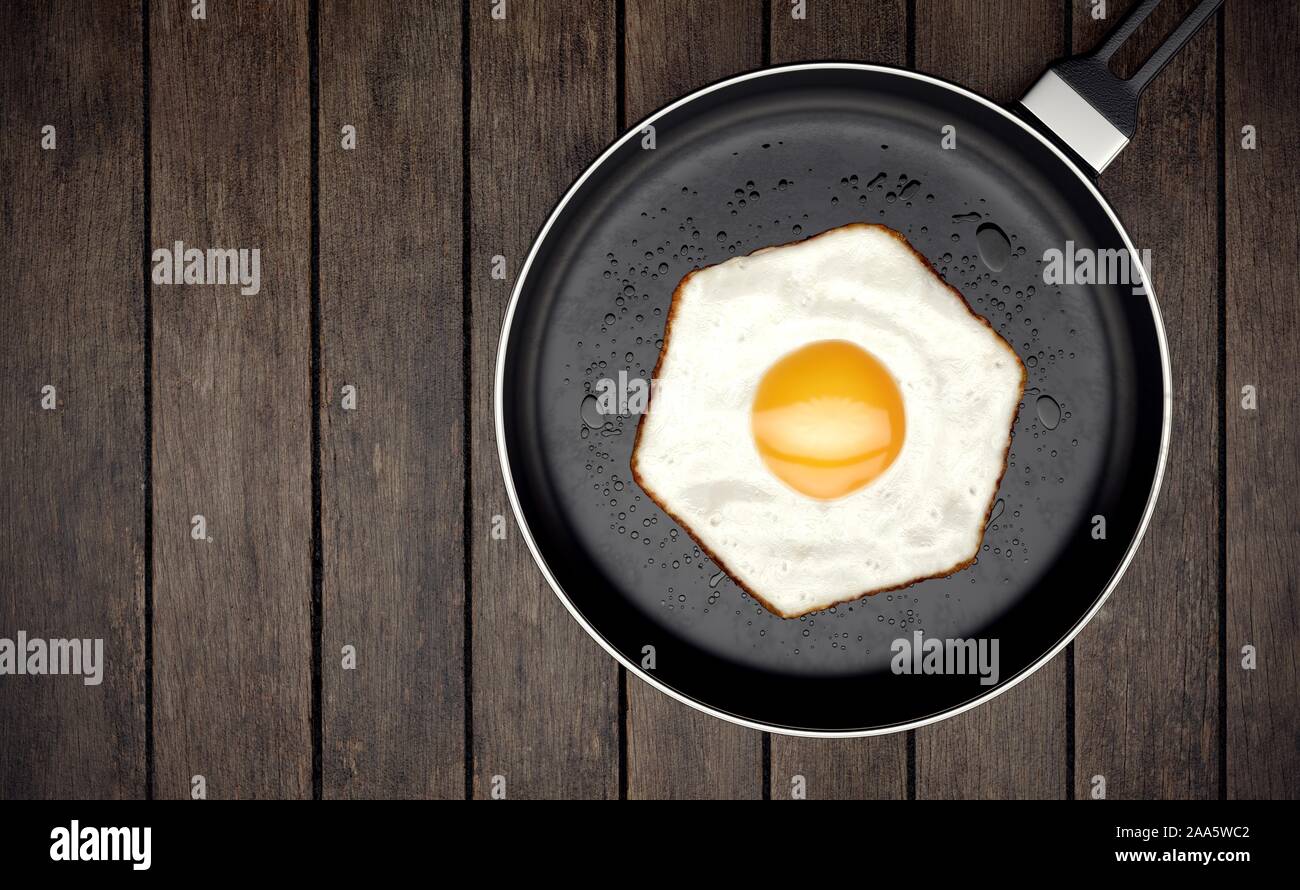 Fried egg with hexagon shape on frying pan on wooden background Stock ...