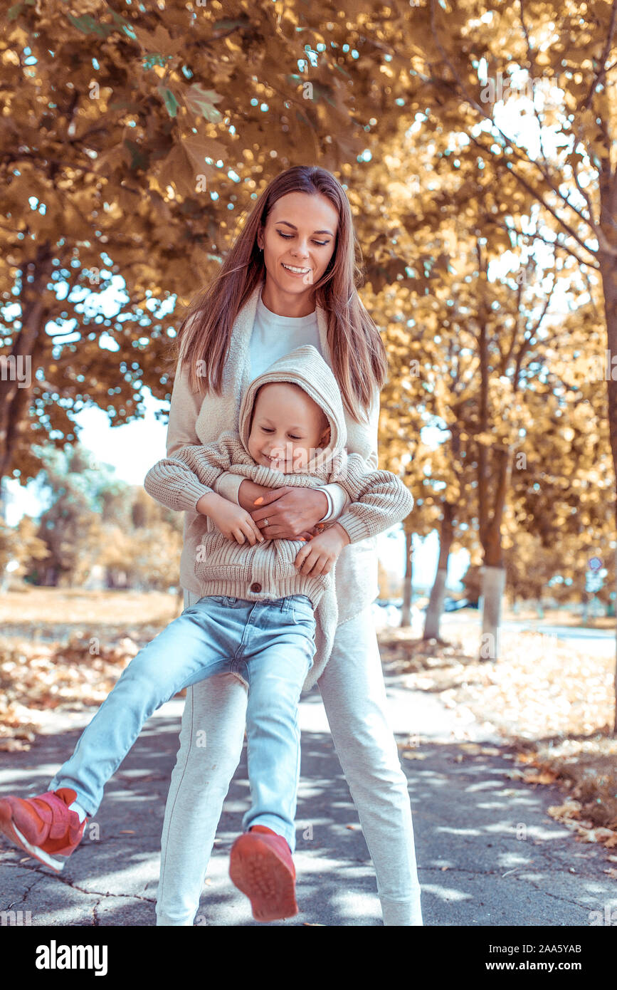 Little boy son, plays mother woman, tenderness and care child, autumn ...