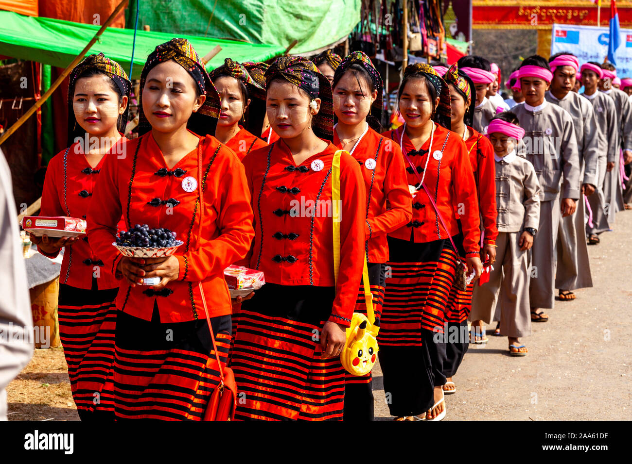 A Procession Of Young Danu Ethnic Minority Women Carrying Offerings At ...