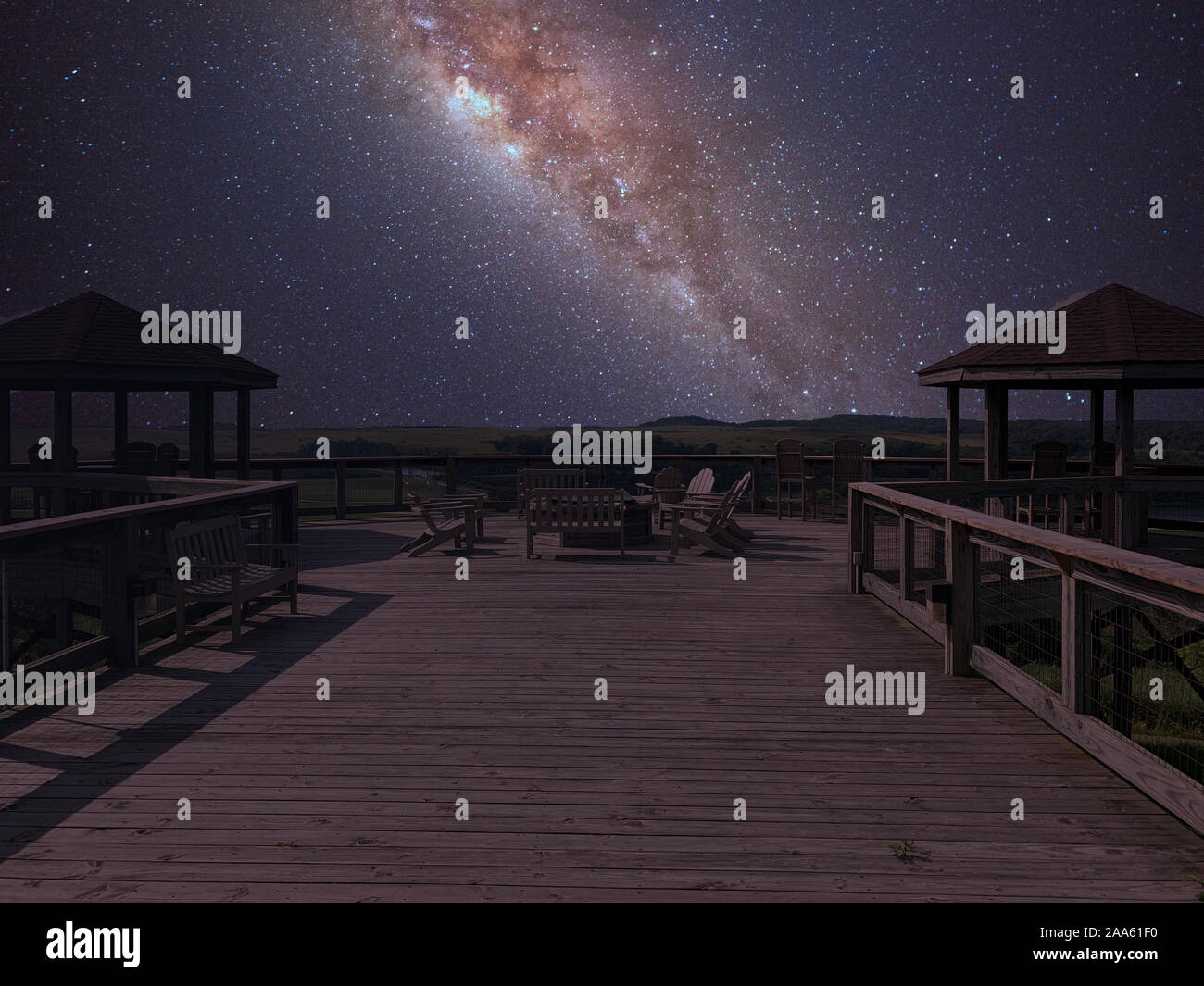 Galaxy between two buildings on a pier on a starry night. Vivid sky ...