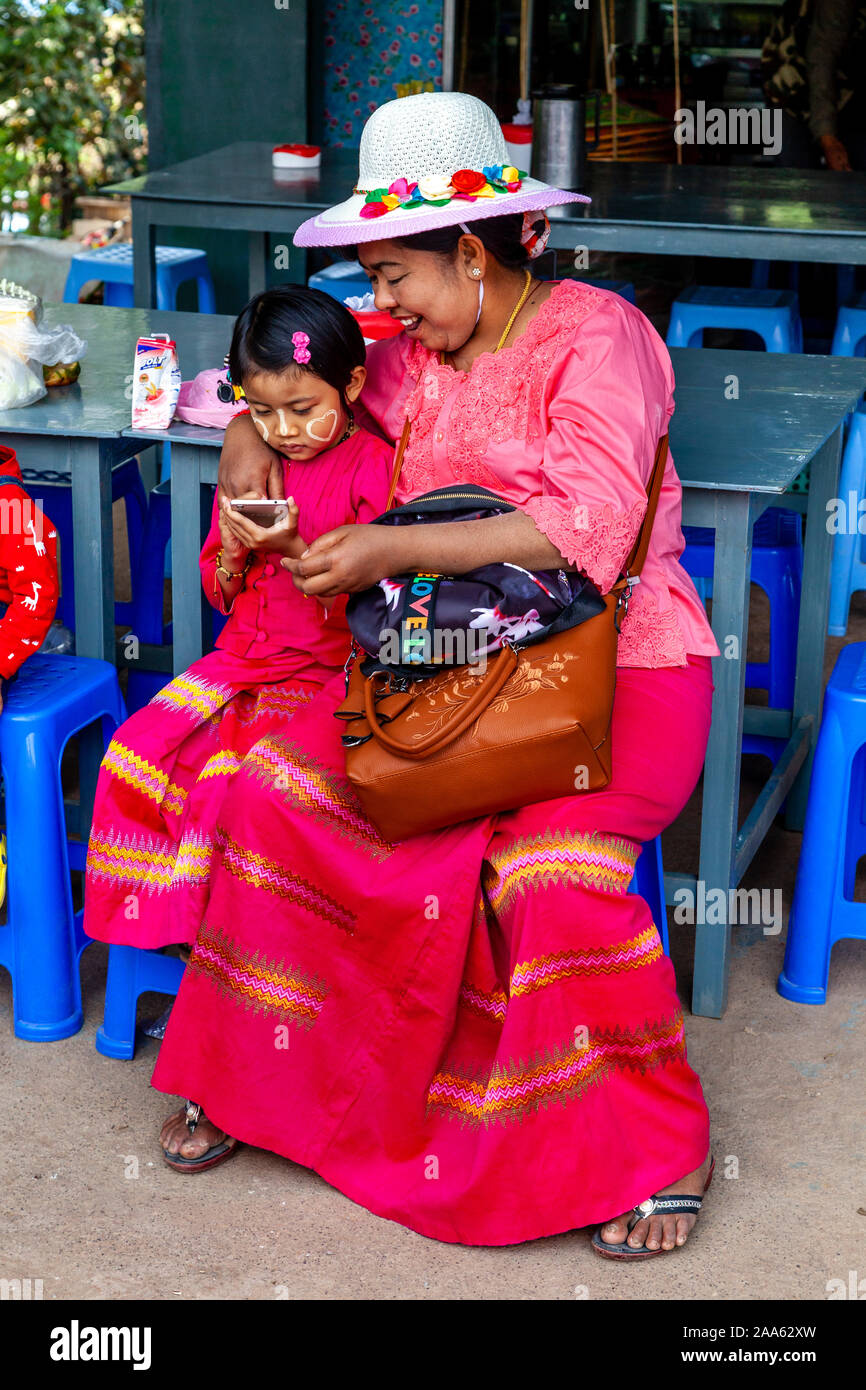 A Burmese Grandmother Looks On With Pride As Her Granddaughter Uses A ...