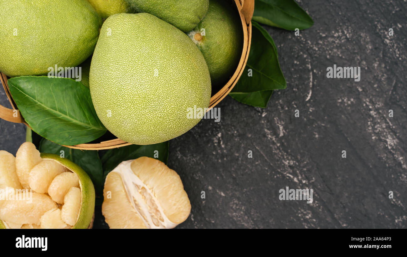 Fresh peeled pomelo, pummelo, grapefruit, shaddock on dark background ...