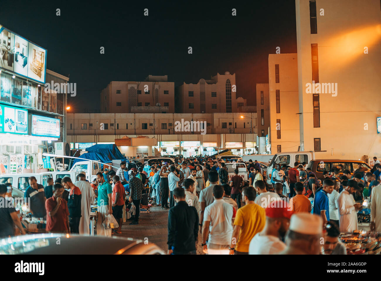 Crowds stroll through Souq Al-Haraj, where vendors hustle clothing and ...