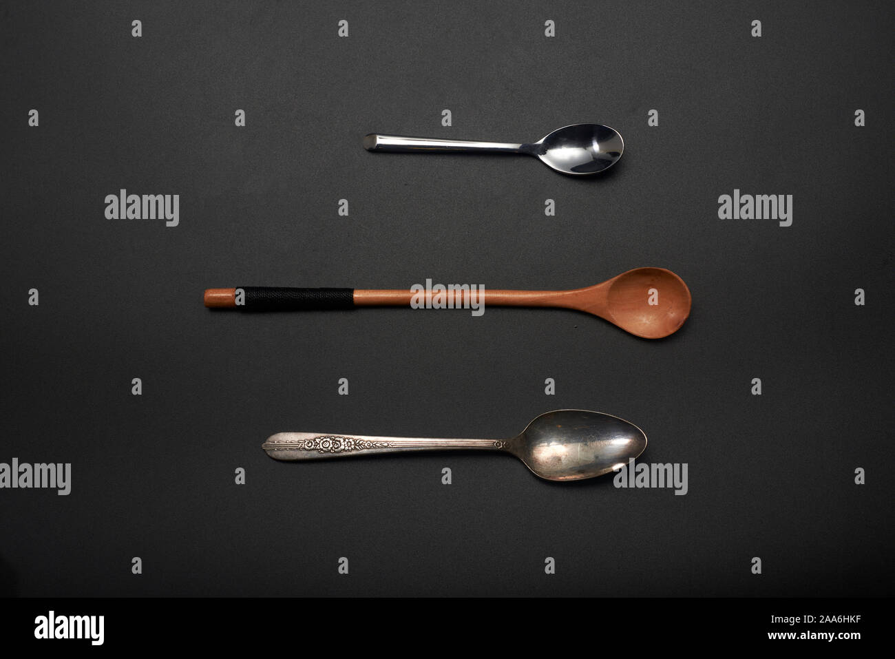 Three different types of spoons, brand new metal spoons, wooden long ...