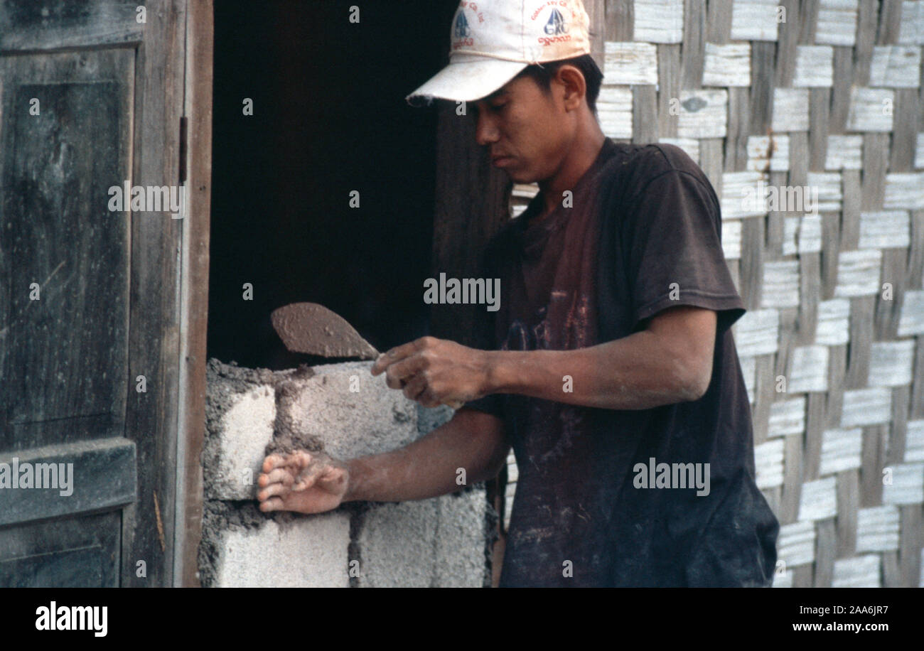An indigenous Karen tribe man building a house in Shan State, Burma ...