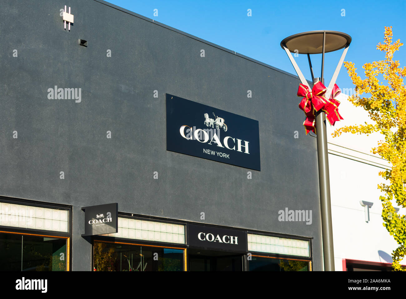 Coach New York logo on luxury accessories store. Christmas holiday bows ...