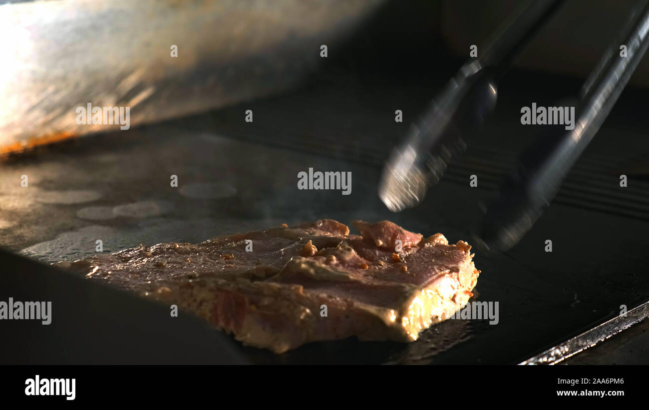 Flips the meat hi-res stock photography and images - Alamy