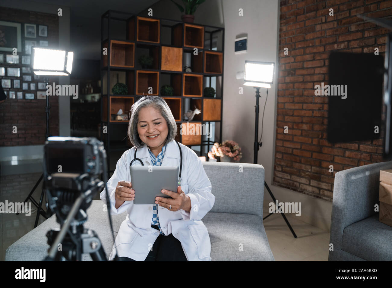 female doctor recording video for his blog Stock Photo - Alamy