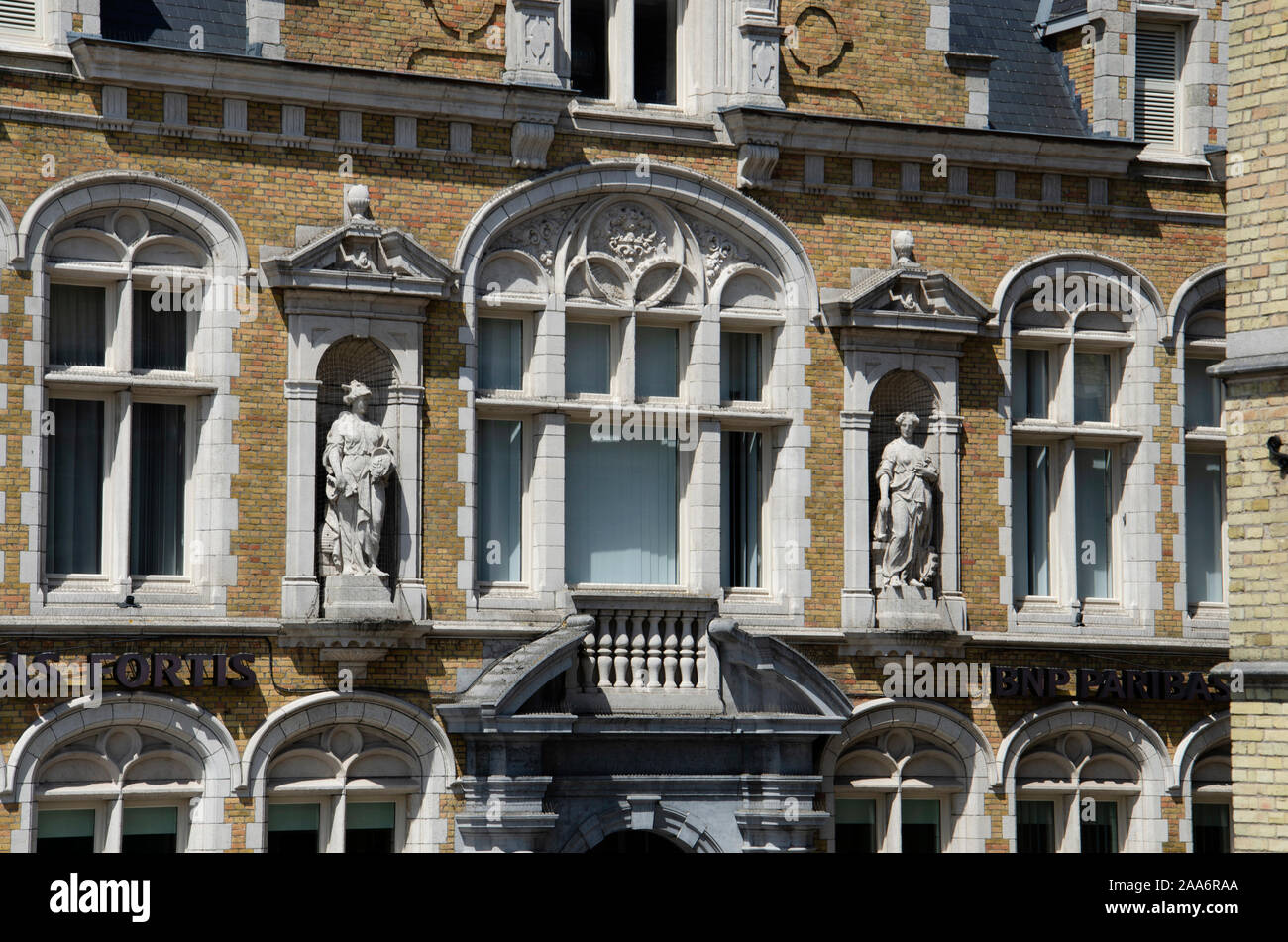 Carved idols on the outer wall of an old building near cloth hall, a ...