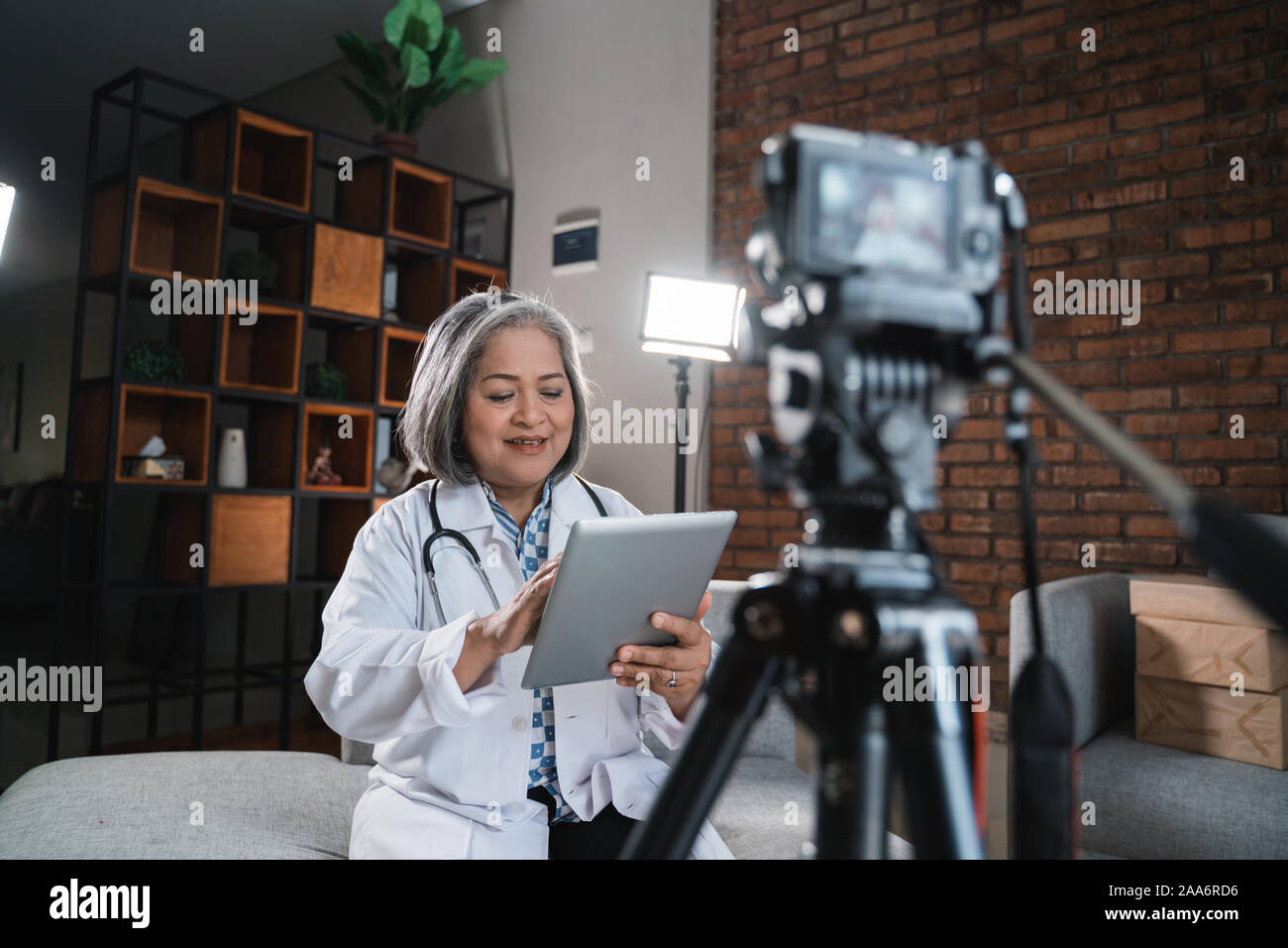 female doctor recording video for his blog Stock Photo - Alamy