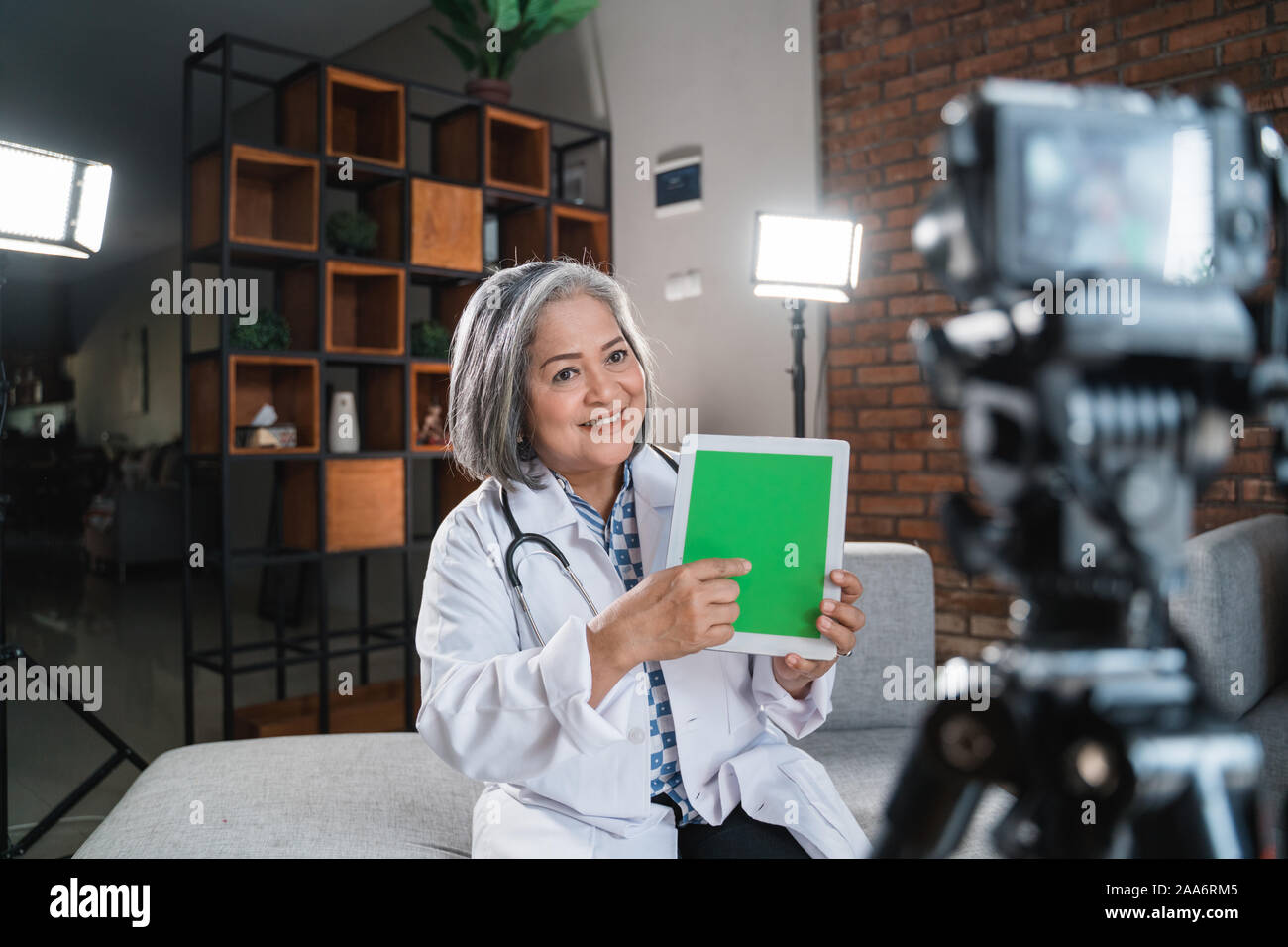 female doctor recording video for his blog Stock Photo - Alamy