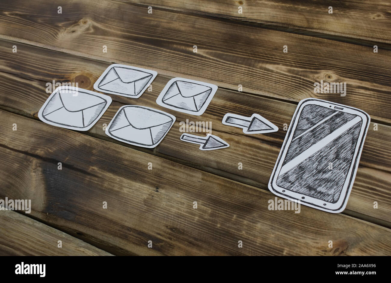 Paper drawn smartphone sketches and letters on wooden Stock Photo - Alamy