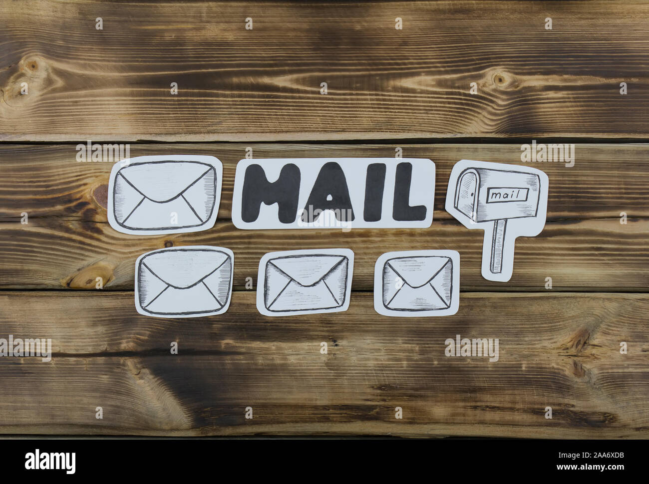 Paper sketched sketches with mail-themed letters on wooden Stock Photo ...