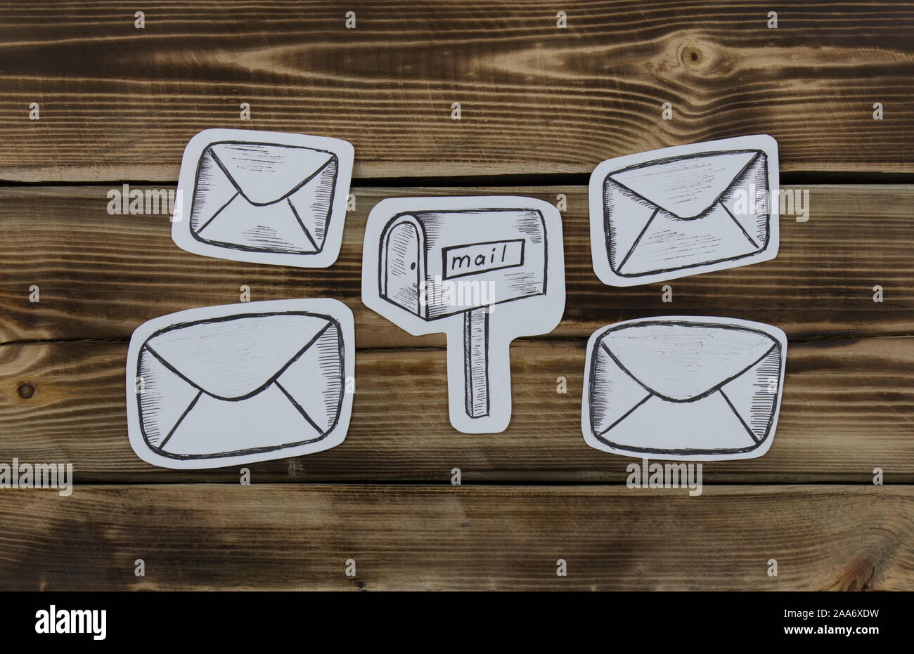 Paper sketched sketches with mail-themed letters on wooden Stock Photo ...