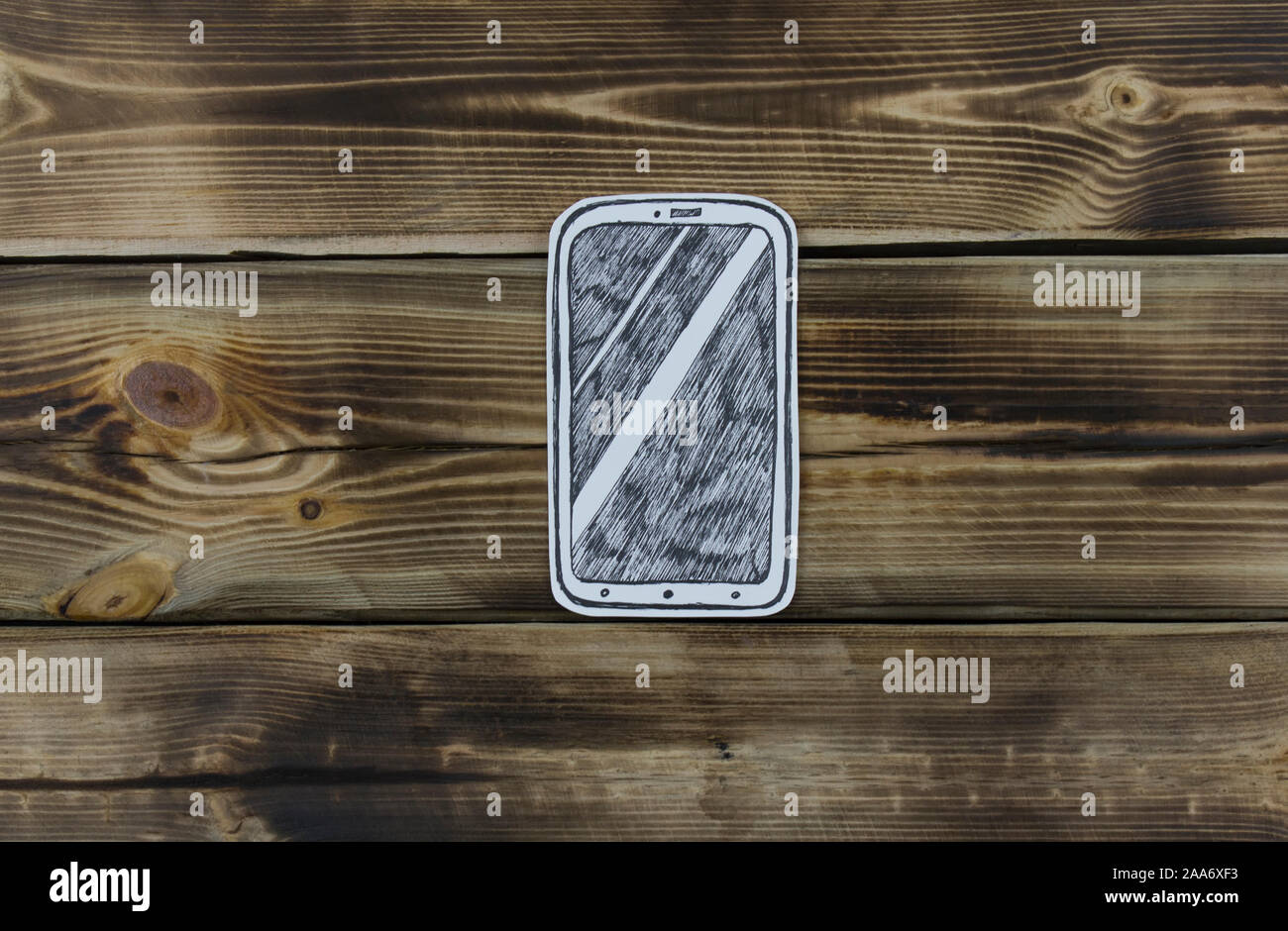 Paper sketch of smartphone on wooden background Stock Photo - Alamy