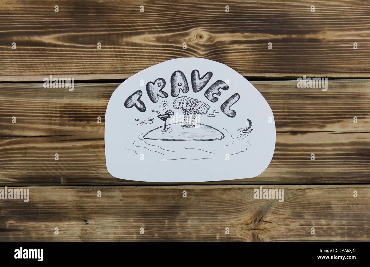Paper sketch with island drawing on wooden background Stock Photo - Alamy
