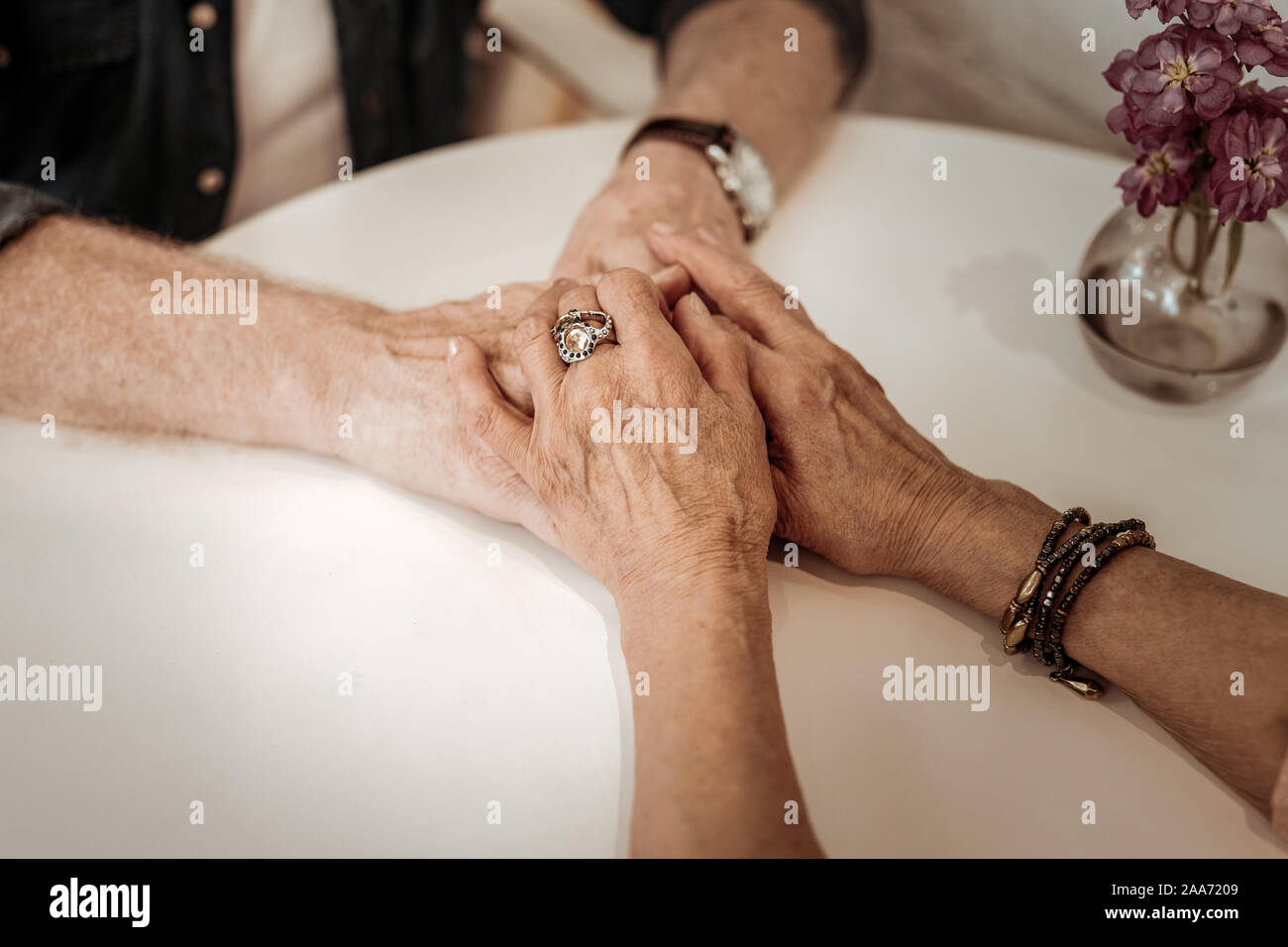 Top view of hands being hold together Stock Photo - Alamy