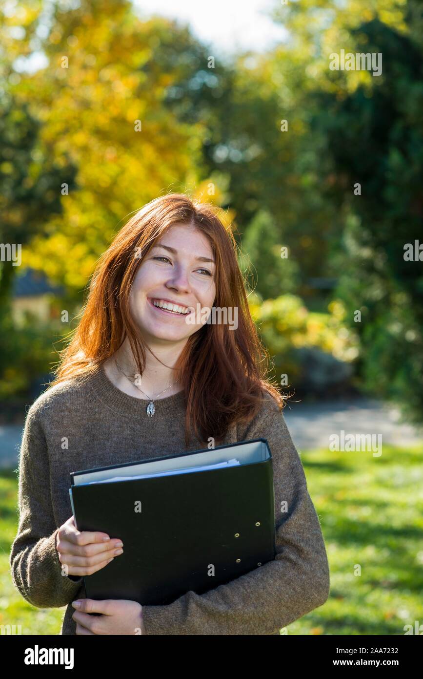 Student with folder outdoors hi-res stock photography and images - Alamy