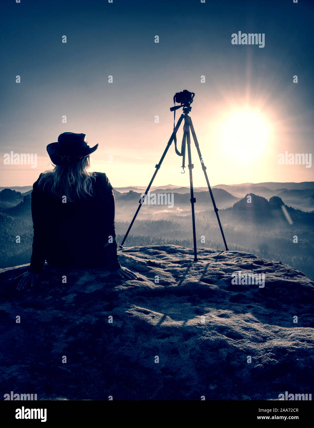 Young woman photographer take a rest after taking picture of landscape ...