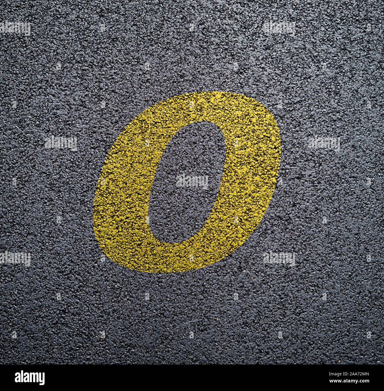 Yellow numbers and signs on the asphalt Stock Photo - Alamy