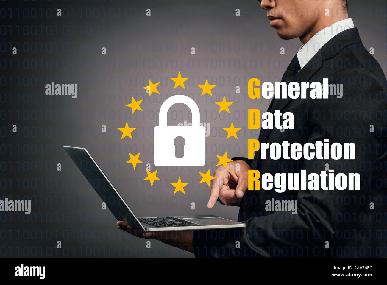 partial view of african american businessman using laptop on dark ...