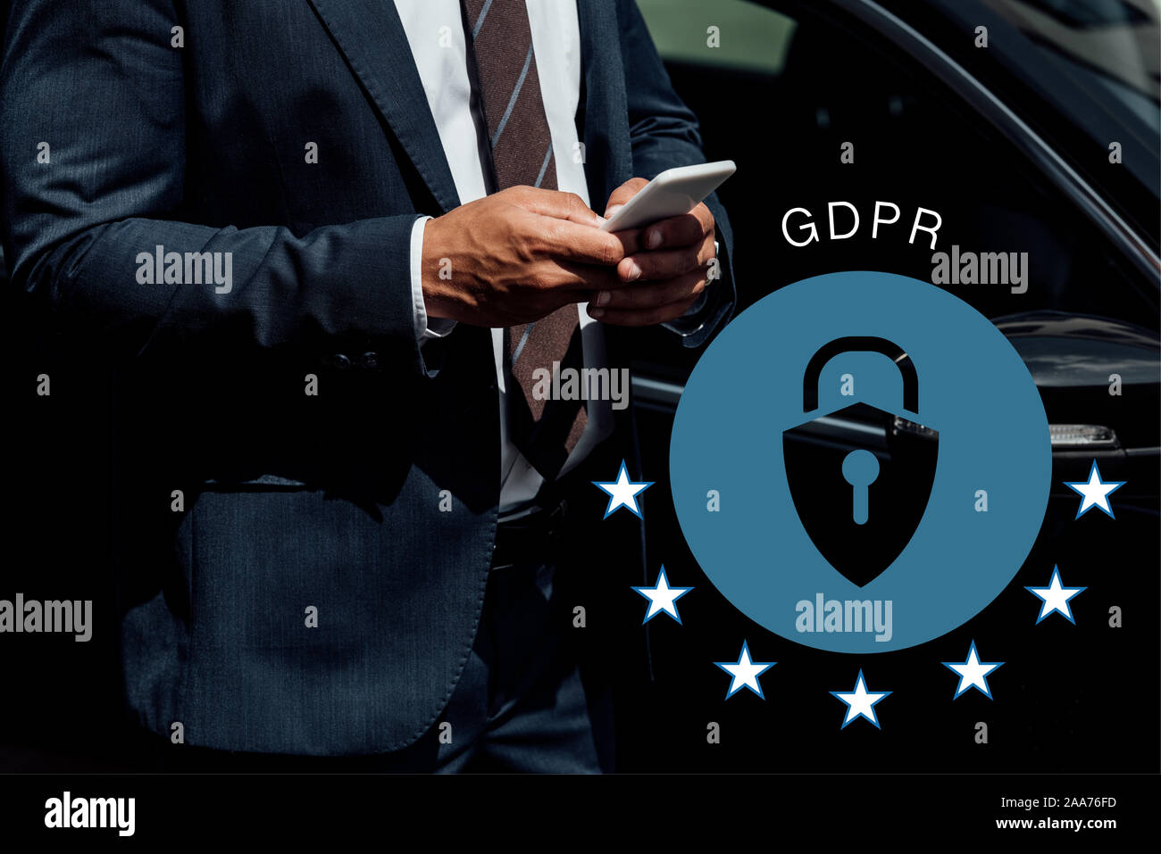 cropped view of african american businessman in suit using smartphone ...