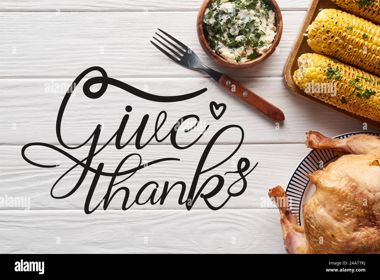 top view of turkey and corn served at white wooden table with give ...