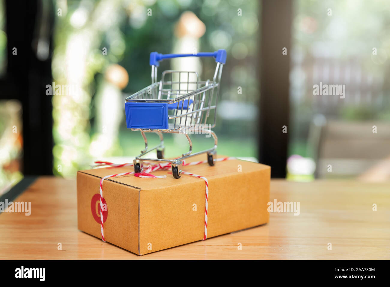 Close up of miniature shopping carts on parcel box. Modern payment ...
