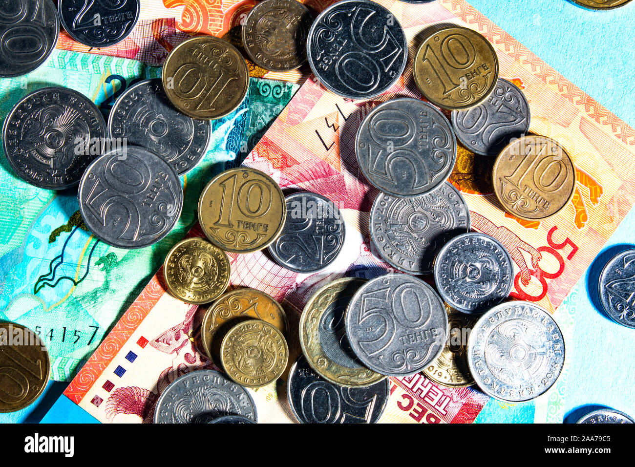Tenge on a blue background with coins. Tenge banknotes. Coins Of ...