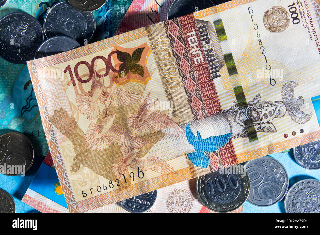 Tenge on a blue background with coins. Tenge banknotes. Coins Of ...
