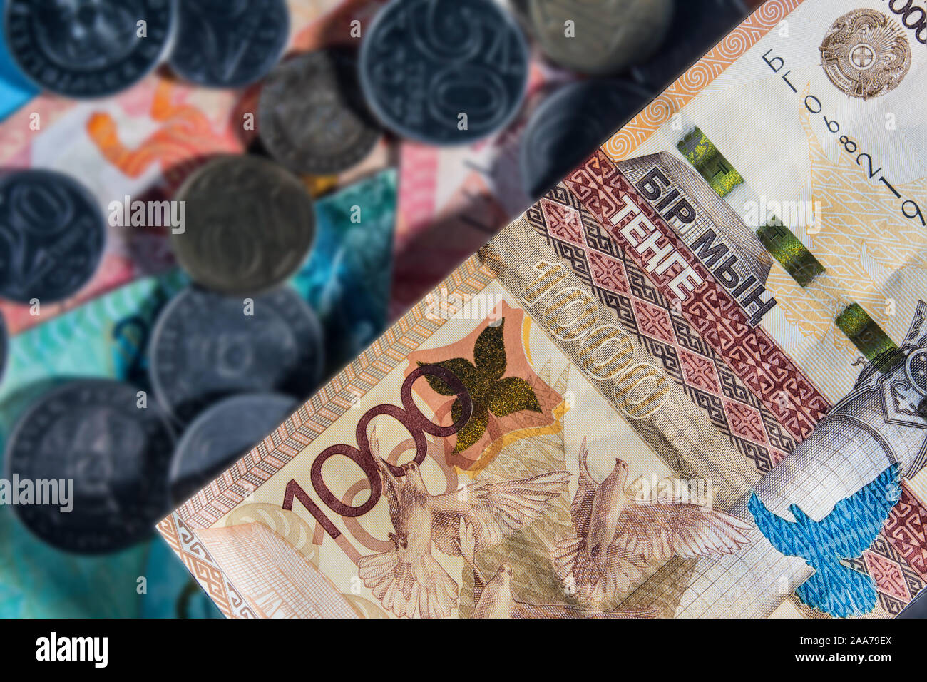 Tenge on a blue background with coins. Tenge banknotes. Coins Of ...