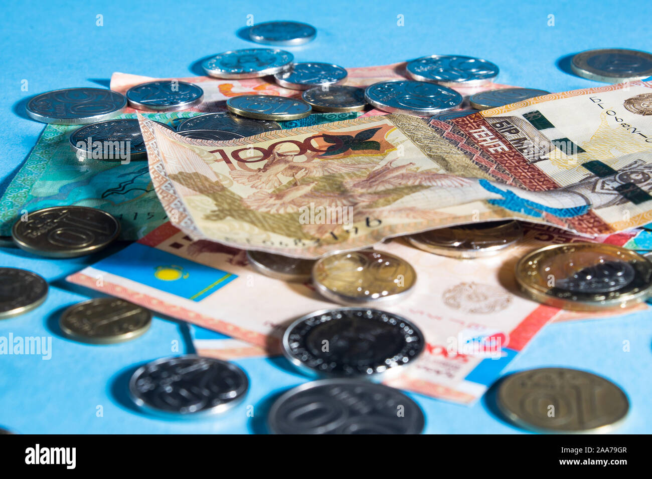 Tenge on a blue background with coins. Tenge banknotes. Coins Of ...