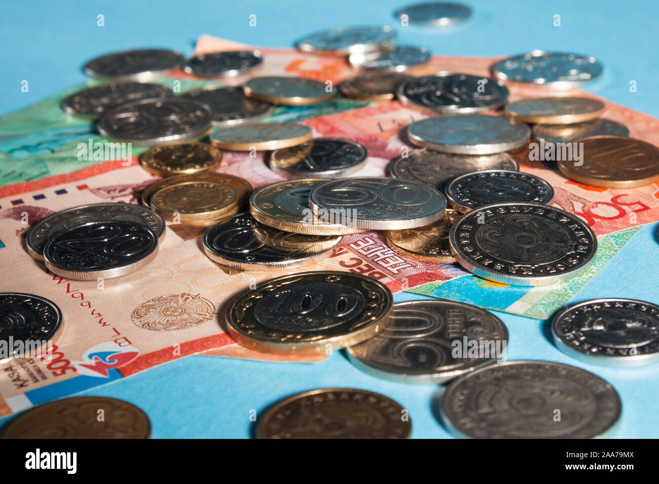 Tenge on a blue background with coins. Tenge banknotes. Coins Of ...