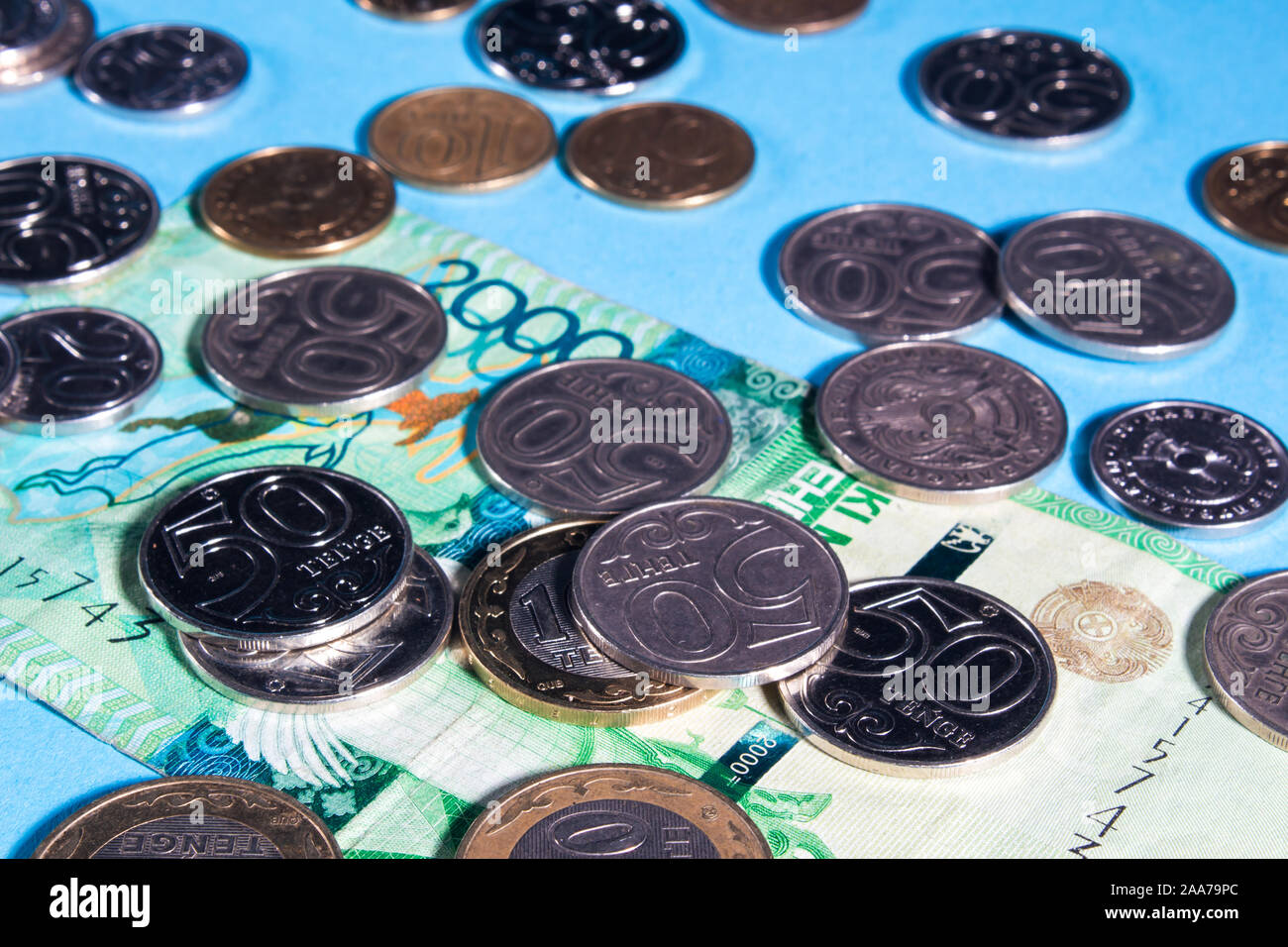 Tenge on a blue background with coins. Tenge banknotes. Coins Of ...
