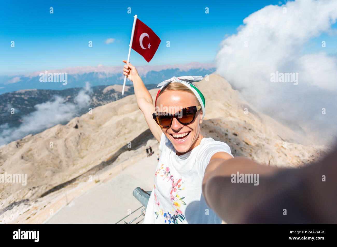 Young woman tourist stands on a viewing platform of Tahtali Mountain in ...