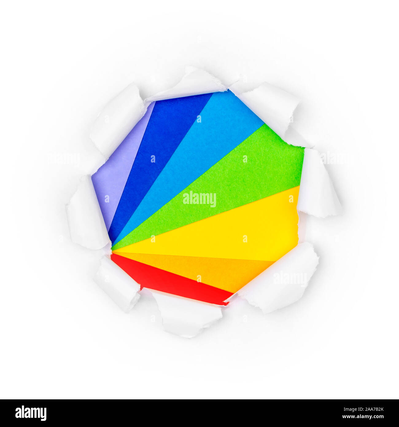 Paper hole in white paper with ragged edges with range of rainbow ...