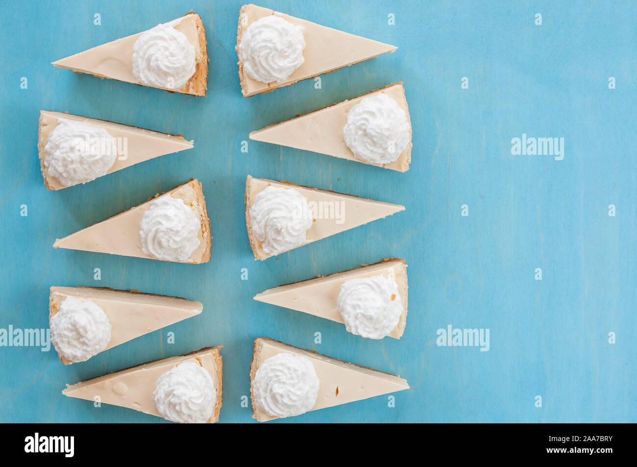Ten pieces of cheesecake on a blue background, top view, like sweet ...