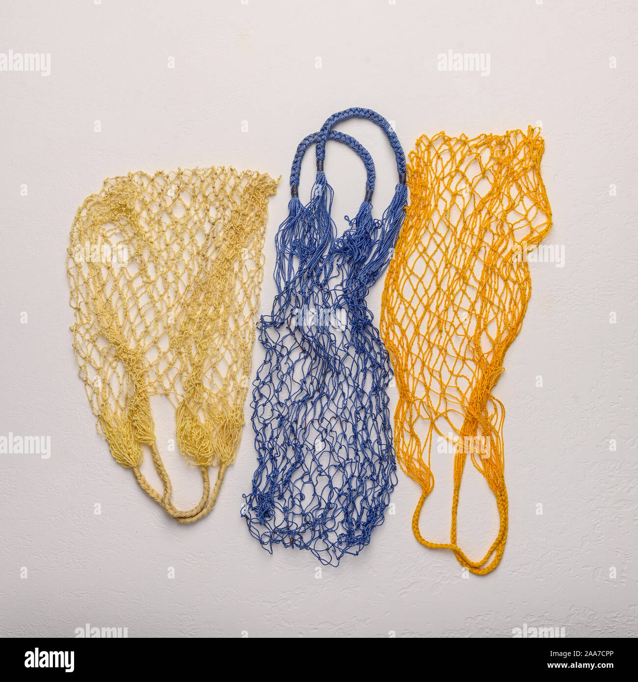 Concept of the three colored string bags made from natural materials on ...