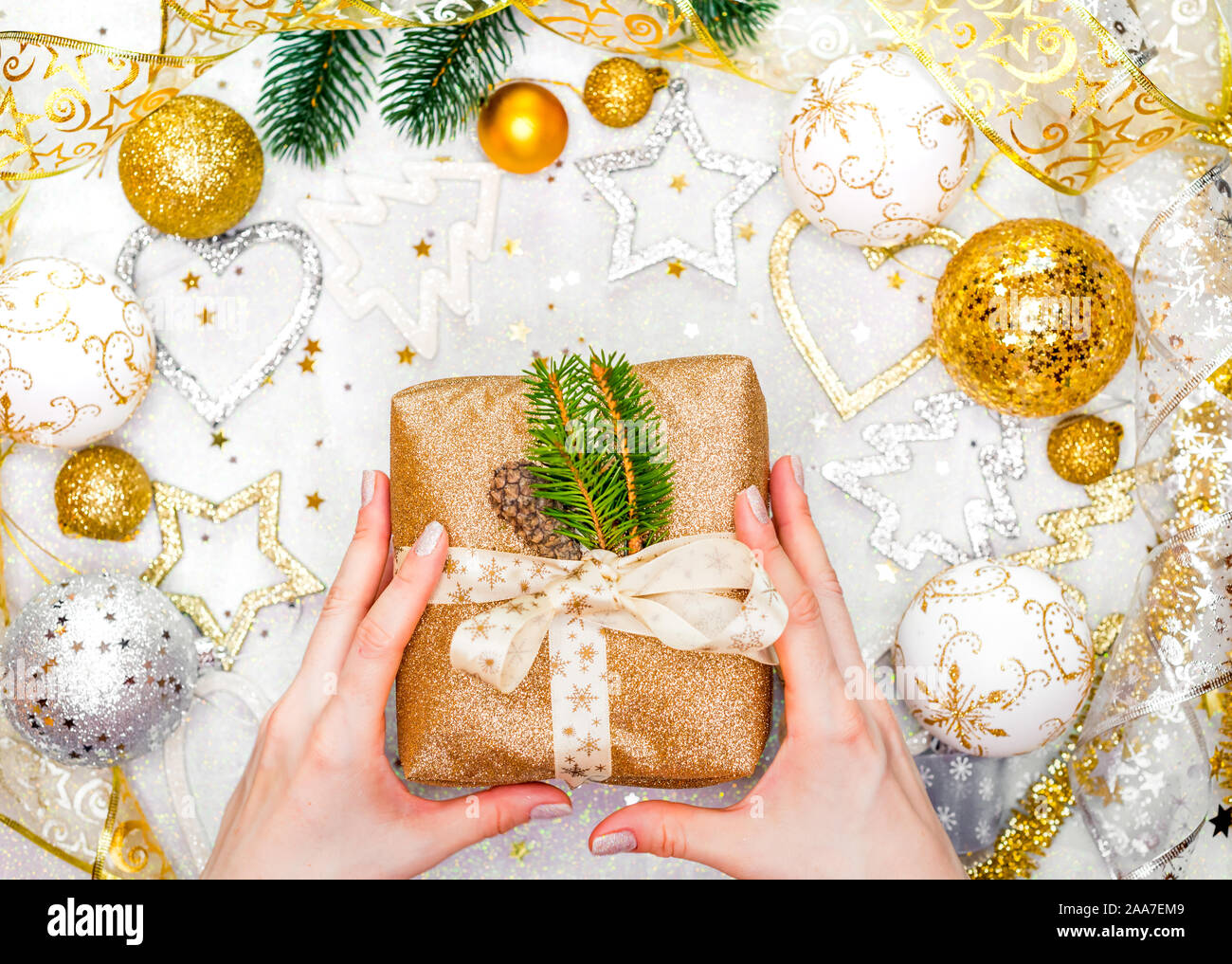 Christmas Present with Gold Ribbon and Gold Christmas Decorations Stock ...