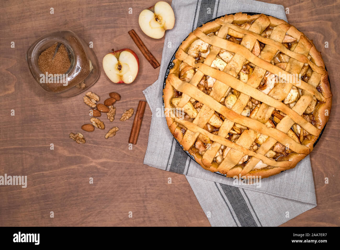 Uncooked homemade rustic apple pie preparation greased with egg yolk on ...