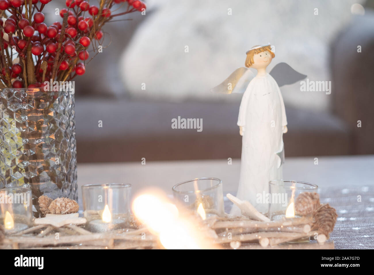 Christmas still life. Angel with red rowan and candles. background ...