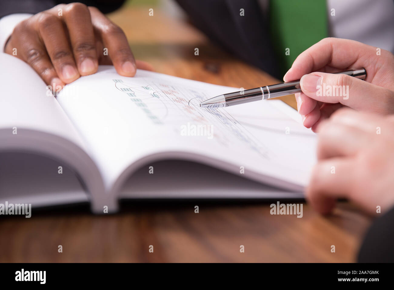 Business people pointing at plan hi-res stock photography and images ...