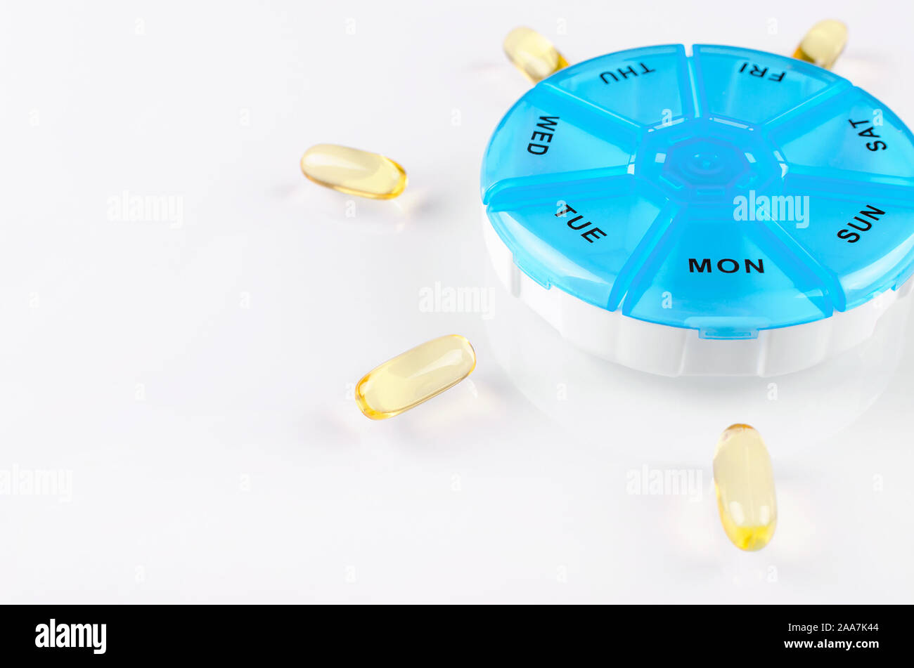 omega capsules with a pills box on white background Stock Photo - Alamy